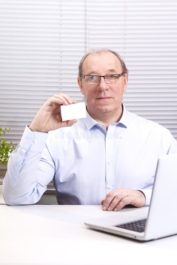 A Man in the Office at the Computer Holds a Sign in His Hands. Stock ...
