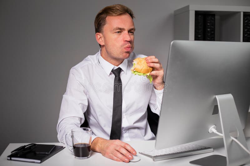 Man at the Office Eating Burger Stock Image - Image of hamburger ...