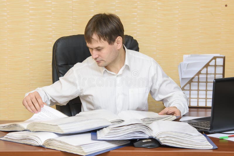 The Man in the Office Looking at Documents in Folders Stock Image ...
