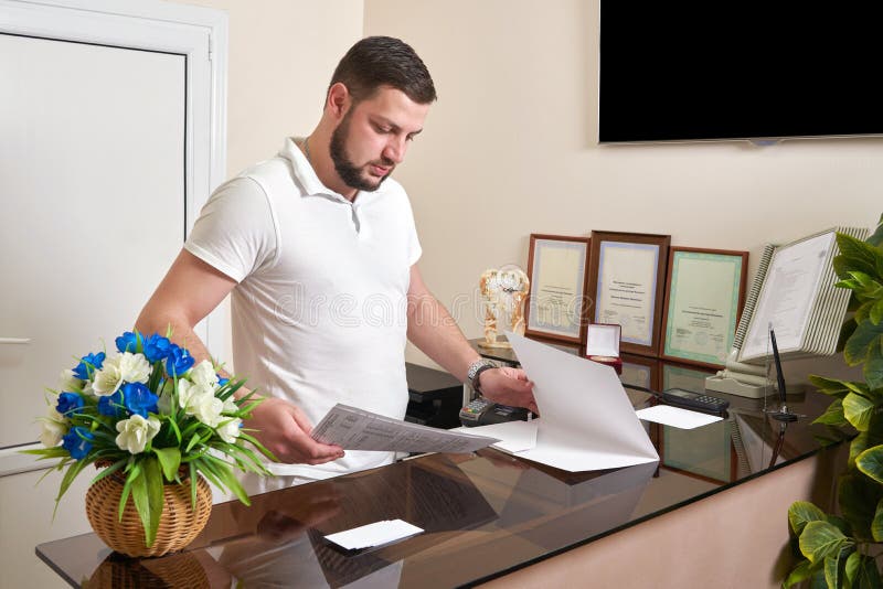 Man Office Reception Desk Working Papers Stock Photos - Free & Royalty ...