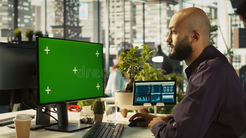 Man in Office Reviewing Financial Graphs on Green Screen PC Stock Photo ...