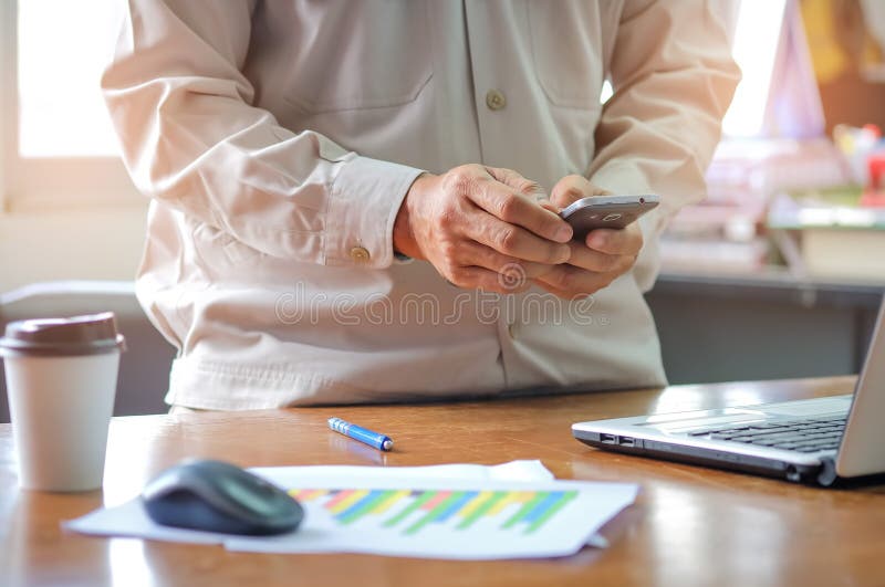 Man Office Staff Using Smart Phone with Analyzing Graphs. Stock Image ...