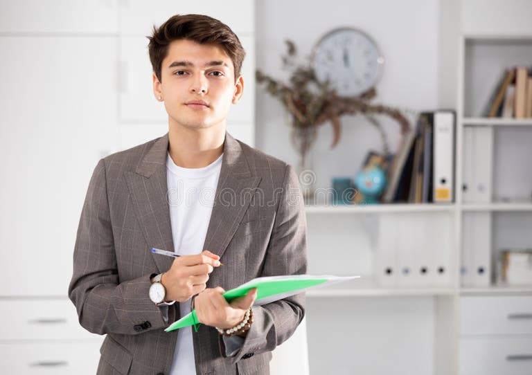 Positive Man Office Worker Holding Folder in Hands and Looking at ...