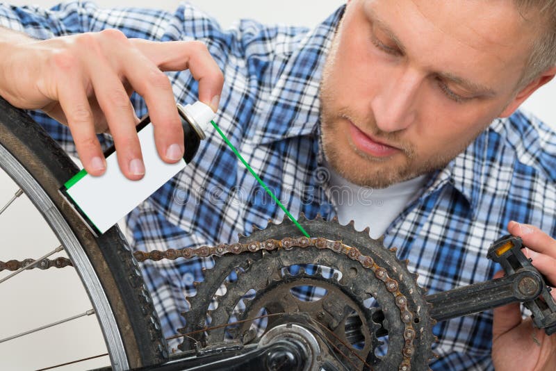 Man Oiling Bicycle Chain stock image. Image of caucasian - 56840121