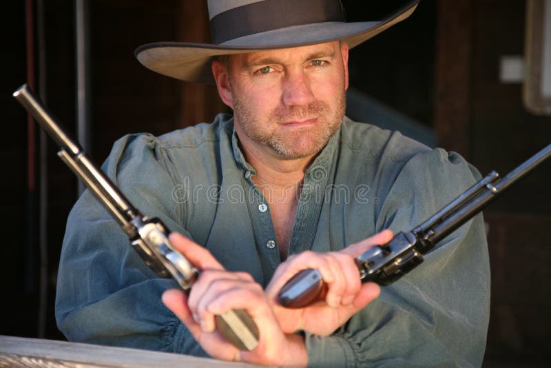 Man in Old West Clothing Wielding Two Pistols Stock Photo - Image of ...