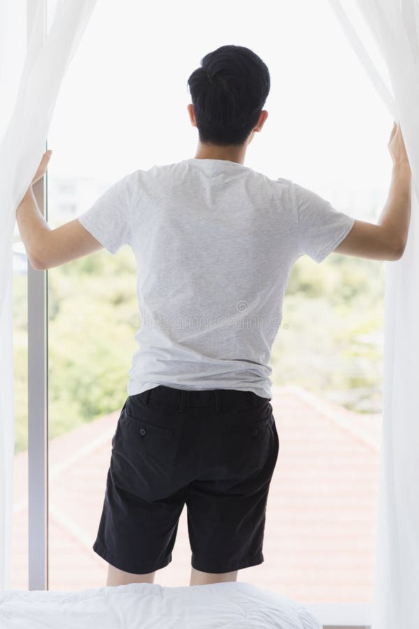 Man Open the Curtain and Look Outside the Window Stock Photo - Image of ...