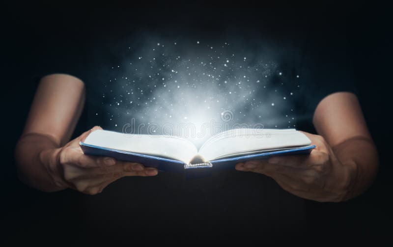 Man Open Magic Book with Growing Lights and Magic Powder Floating on ...