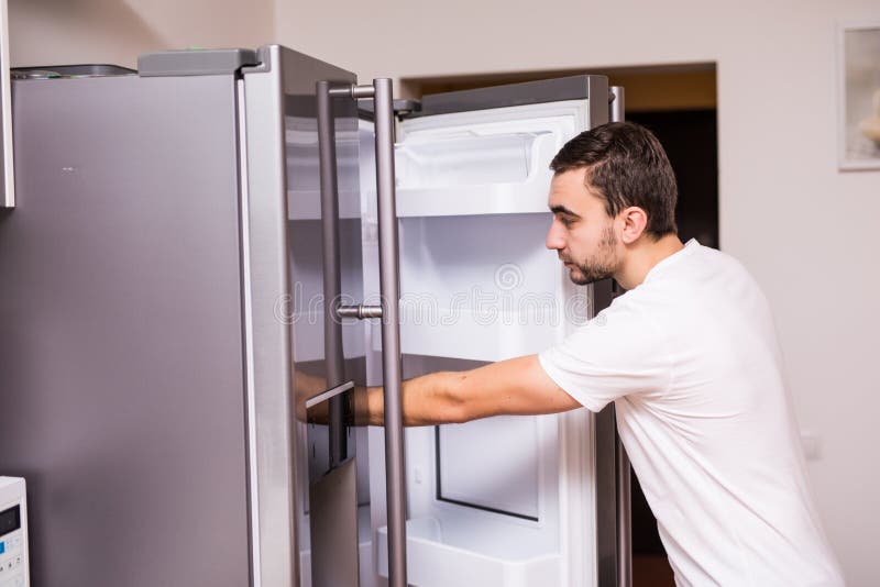 Man Open Refrigerator Door in the Kitchen at Home Stock Image - Image ...