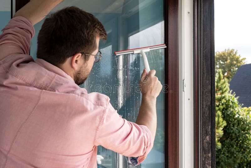 Man Opened the Window Sash and Washes the Glass from Dust and Dirt with ...