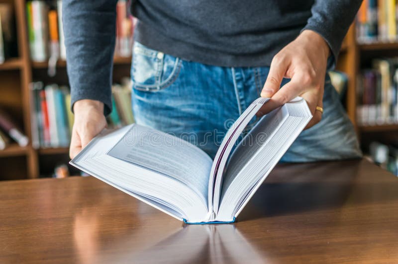 The Man Opening and Browsing the Book Pages Stock Image - Image of ...