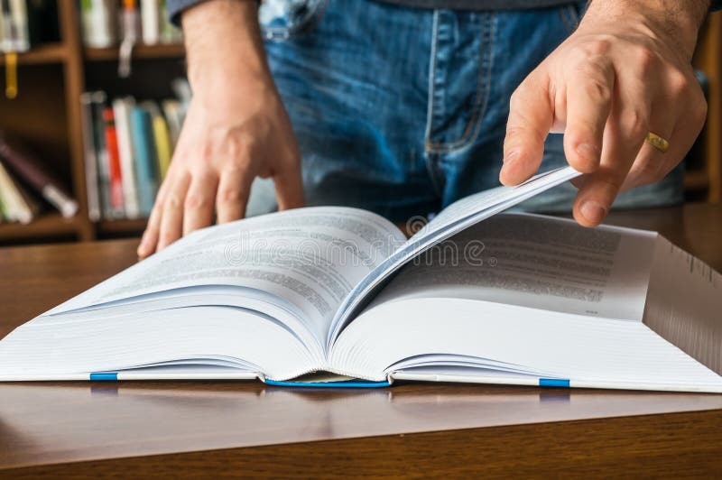 The Man Opening and Browsing the Book Pages Stock Image - Image of ...
