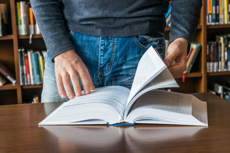 The Man Opening and Browsing the Book Pages Stock Image - Image of ...