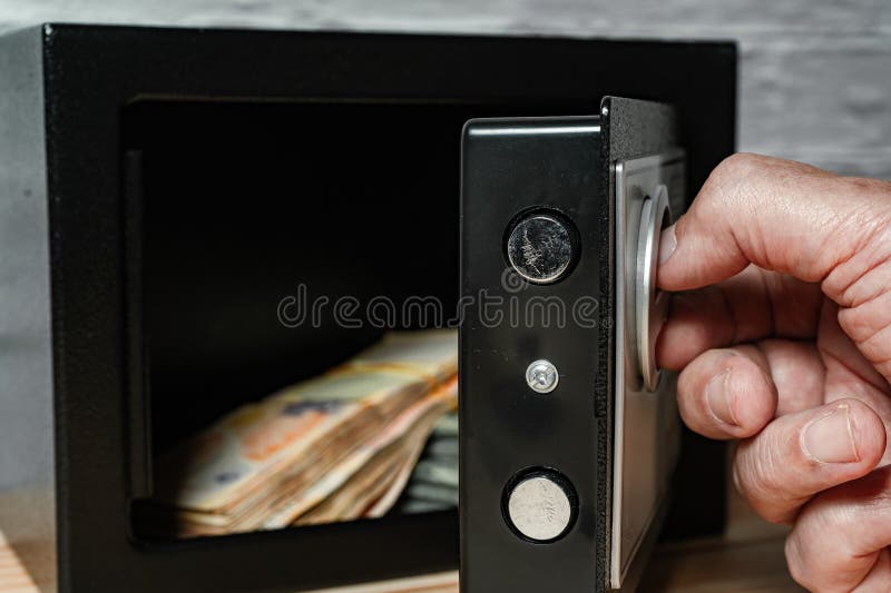 Man Opening the Door of a Home Safe by Turning the Security Lock Stock ...