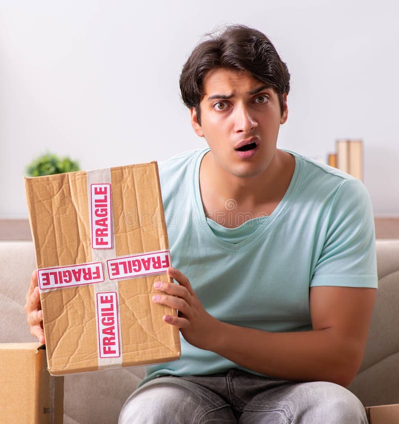 Man Opening Fragile Parcel Ordered from Internet Stock Image - Image of ...