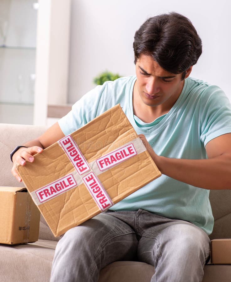 Man Opening Fragile Parcel Ordered from Internet Stock Photo - Image of ...