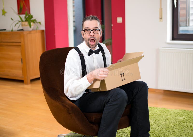 Man Opening a Package and is Amazed Stock Photo - Image of living ...