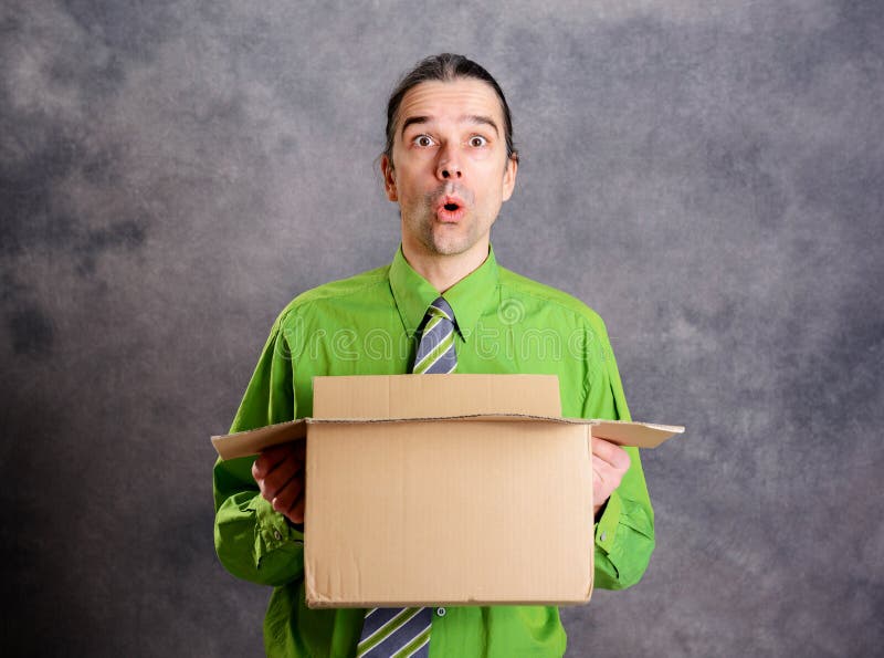 Man Opening a Package and Looking Surprised Stock Image - Image of ...