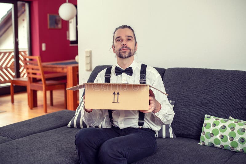 Man opening a package stock photo. Image of amazed, handsome - 138334264