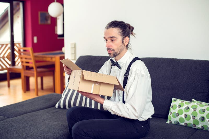 Man opening a package stock photo. Image of opening, surprise - 68526030