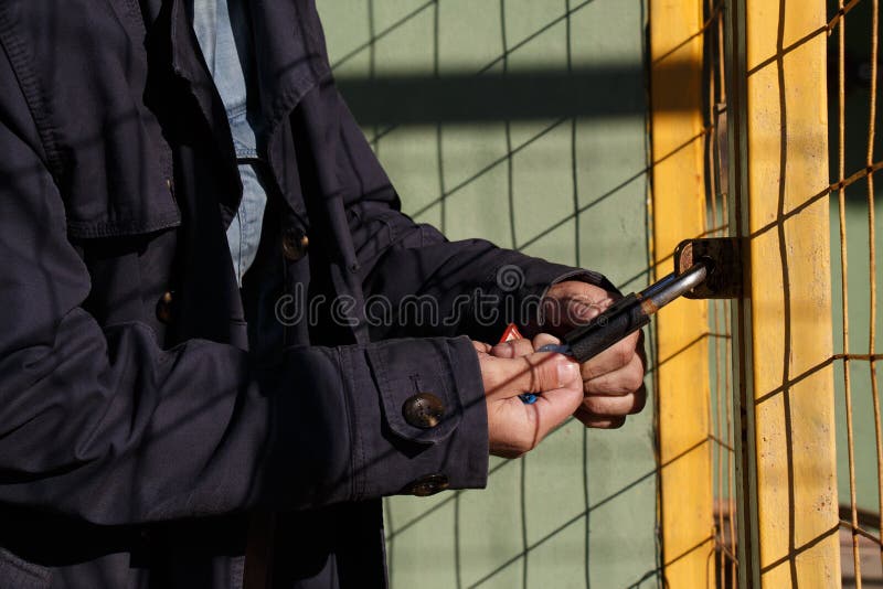 Man opening padlock stock photo. Image of appliance, human - 62945716