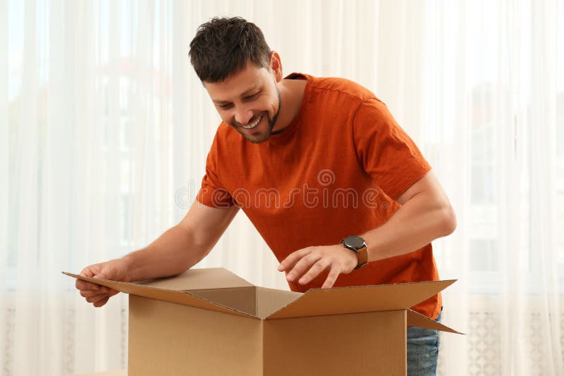 Happy Man Opening Parcel at Home. Internet Shopping Stock Image - Image ...