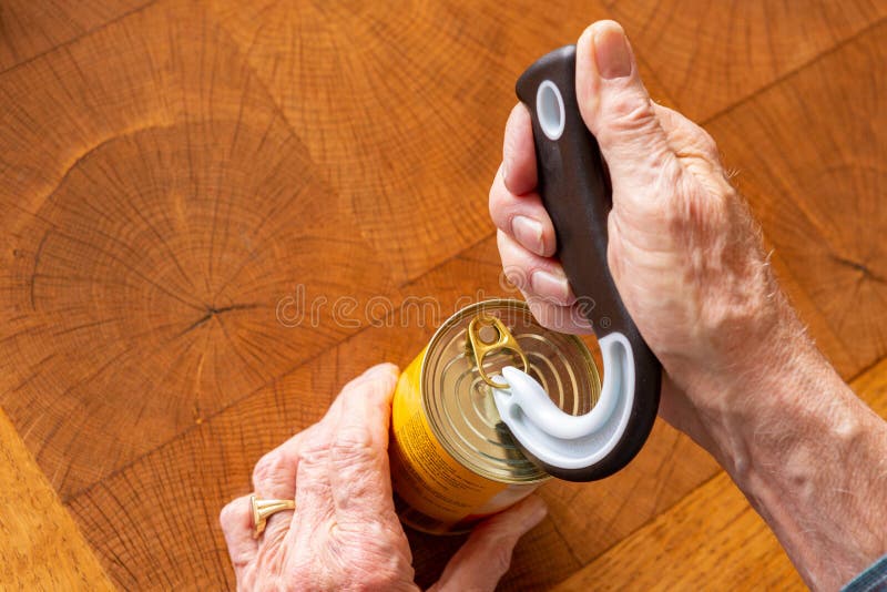 Man Opening a Tin Can with a Special Opener Stock Photo - Image of ...