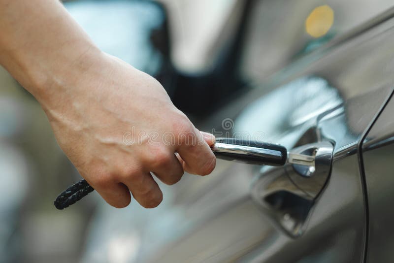 A Man Opens a Car Door with a Key, Close-up Hand. Dead Battery in ...