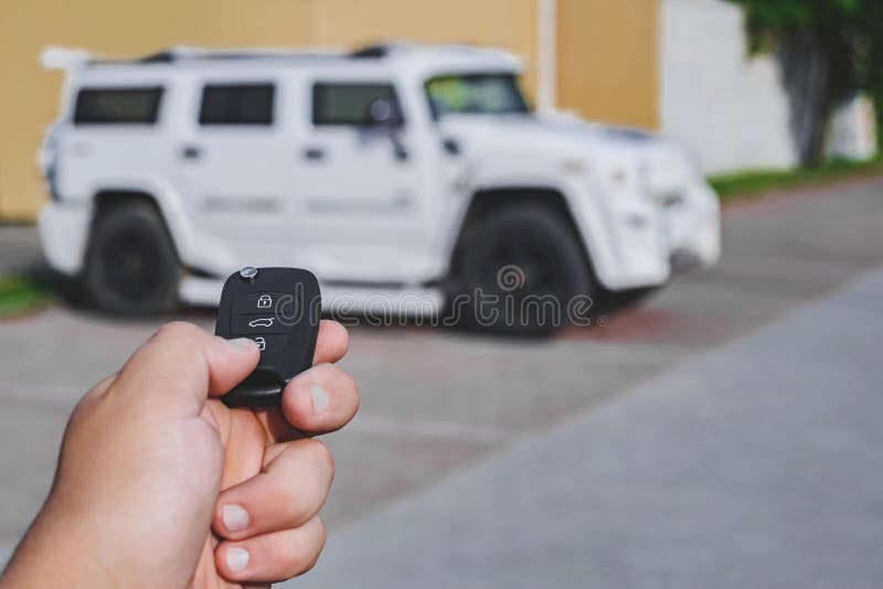 The Man Opens the Car with a Key Fob. in the Background is a White Car ...