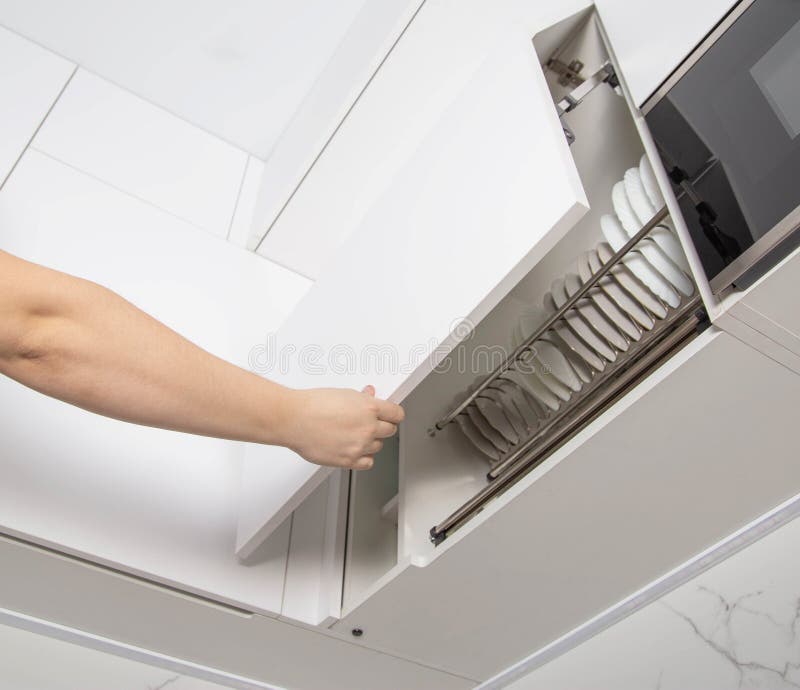 A Man Opens the Door of the Kitchen Facade with a Lifting Mechanism ...