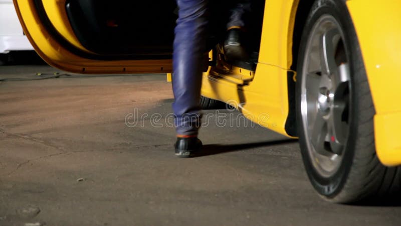 Man Opens Door and Sits in Yellow Car, only Legs Stock Footage - Video ...