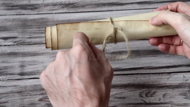 The Man Opens the Scroll. the Hand of Men Unfolds the Old Antique ...