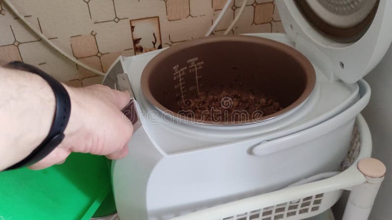 Man Opens a Slow Cooker with Buckwheat Stock Photo - Image of recipe ...