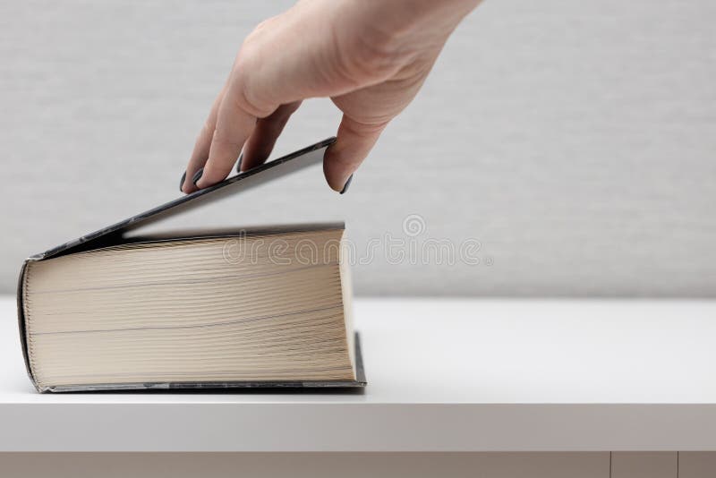 Man Opens a Thick Book Lying on the Table Stock Photo - Image of page ...