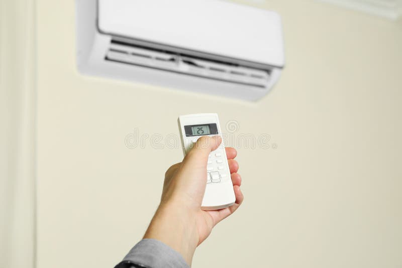 Man Operating Air Conditioner with Remote Control Indoors, Closeup ...