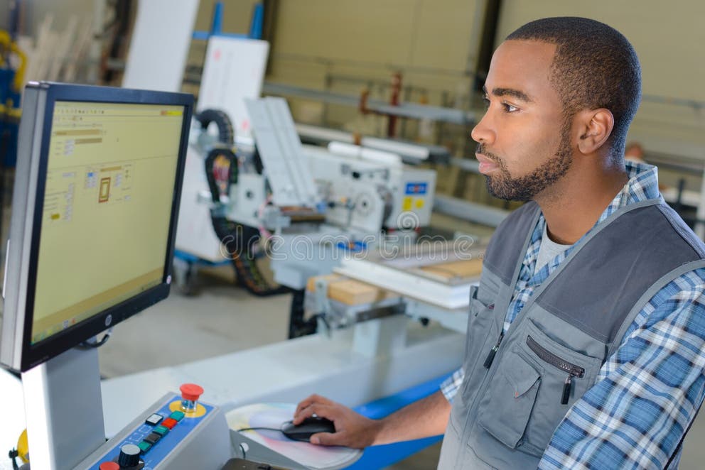 Man Operating Computer in Industrial Setting Stock Image - Image of ...