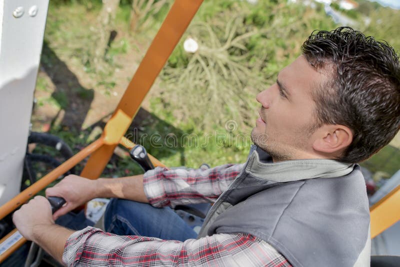 Man operating digger stock image. Image of equipment - 292896035