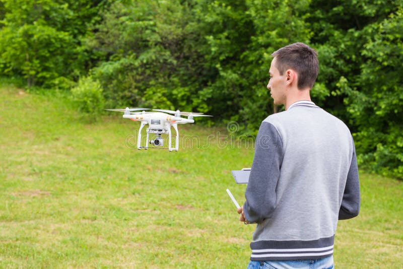 Ufa, Russia. - 6 June 2016 : Man Operating Drone Flying or Hovering by ...