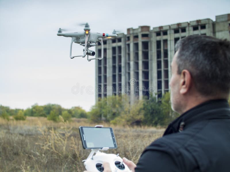 Man Operating a Drone Quad Copter with Onboard Digital Camera Stock ...