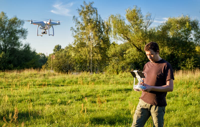 Man Operating a Drone Quad Copter in the Park Stock Photo - Image of ...