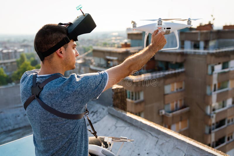 Man Operating a Drone with Remote Control on Rooftop Stock Image ...