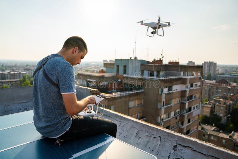Man Operating a Drone with Remote Control on Rooftop Stock Photo ...