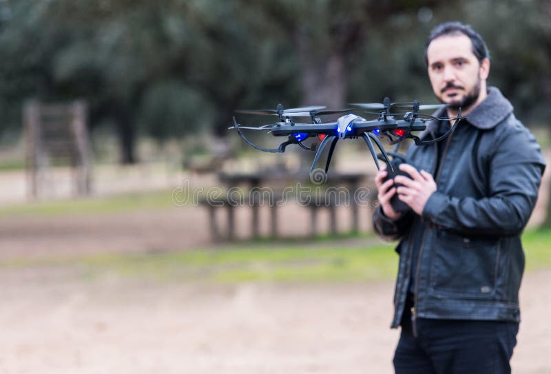 A Man Operating the Drone by Remote Control in the Park Stock Photo ...