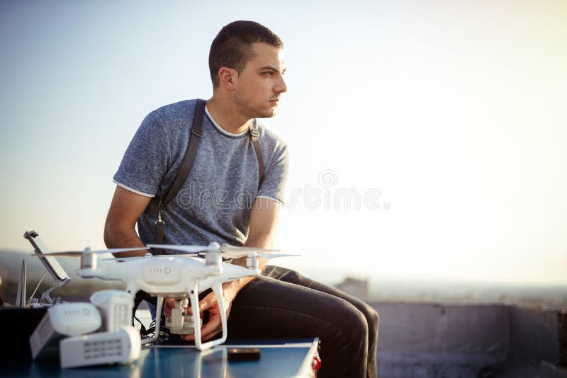 Man Operating A Drone With Remote Control On Rooftop Stock Image