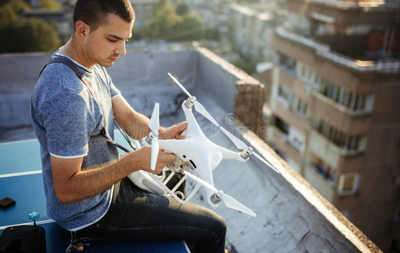 Man Operating a Drone with Remote Control on Rooftop Stock Photo ...