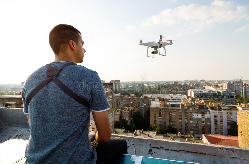 Man Operating a Drone with Remote Control on Rooftop Stock Photo ...