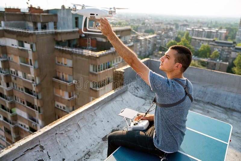 Man Operating a Drone with Remote Control on Rooftop Stock Image ...
