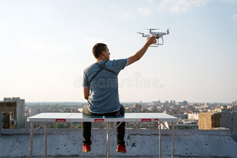 Man Operating a Drone with Remote Control on Rooftop Stock Image ...