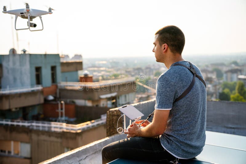 Man Operating a Drone with Remote Control on Rooftop Stock Image ...