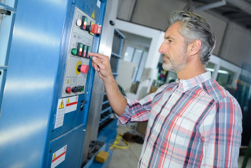 Man Operating Factory Equipment Stock Image - Image of buttons, plaid ...