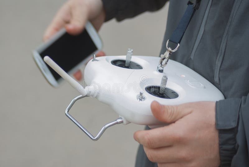 Man Operating Flying Drone with Remote Controller and Smart Phone Stock ...